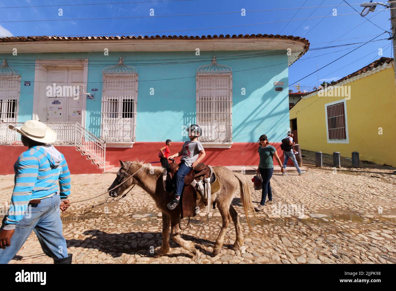 The colonial old town with local people and colorful buildings Trinidad ...