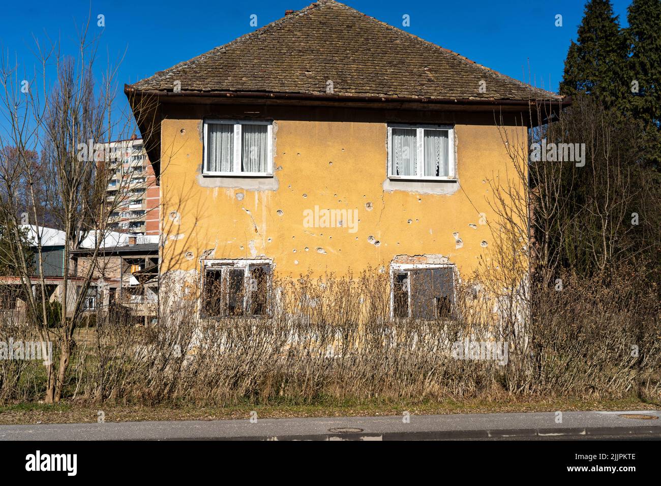 An old yellow building with cracked walls in Maglaj, Bosnia Stock Photo ...