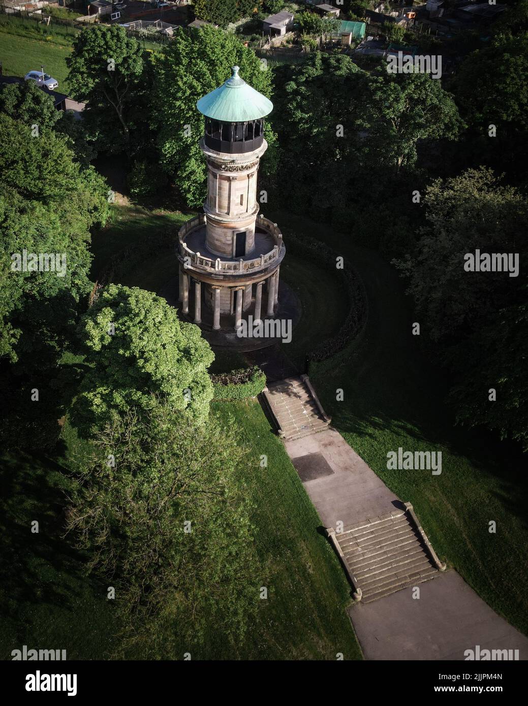 A vertical drone shot of the Locke Park Tower in Barnsley surrounded by ...