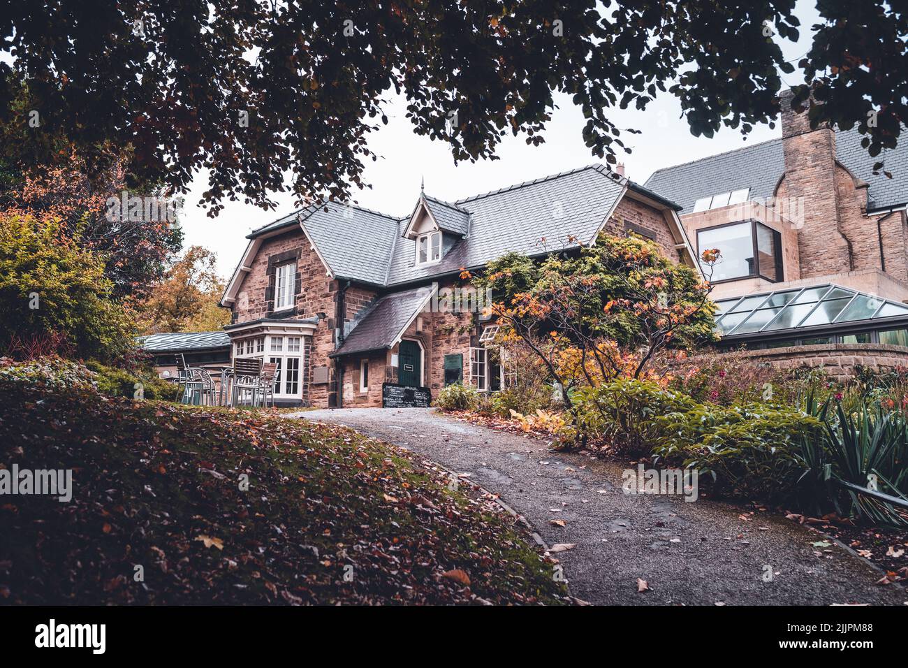 A beautiful traditional English house next to the garden in autumn in ...