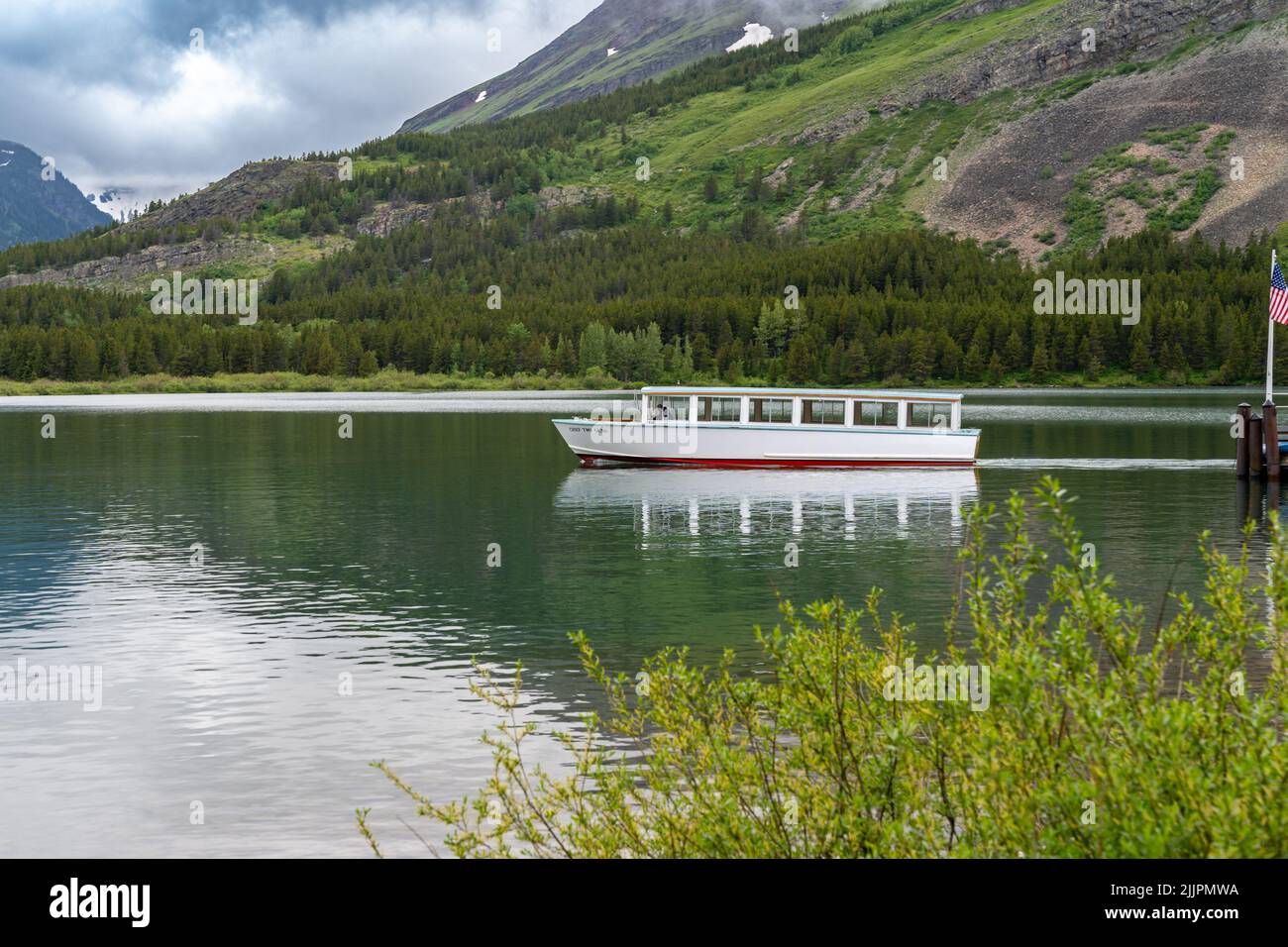 Montana, USA - July 4, 2022: A Many Glacier boat shuttle makes its way ...