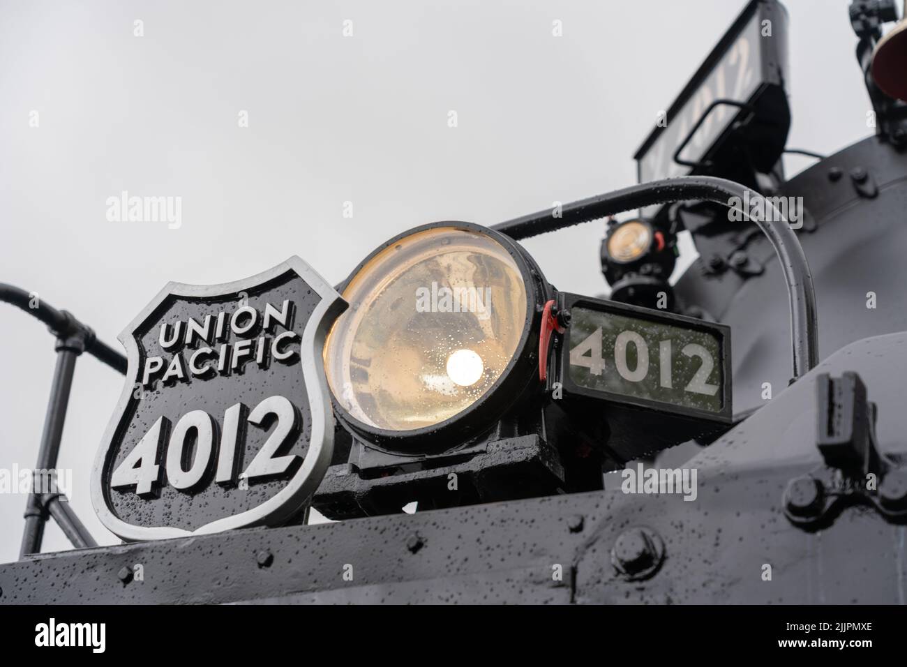 A grayscale of an old and historic steam train on track in a museum ...