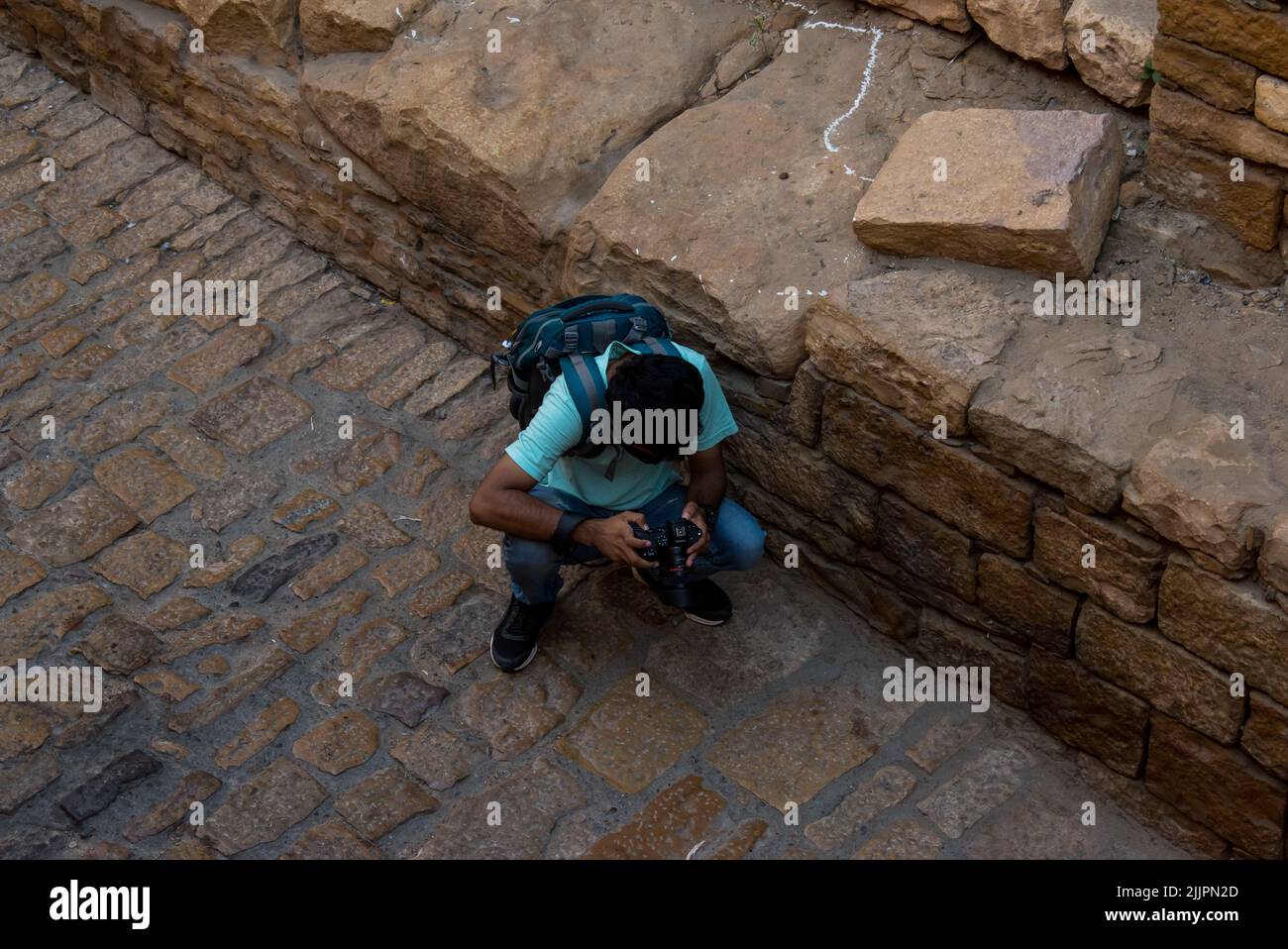 A traveler photographer is reviewing his clicked picture on the camera ...