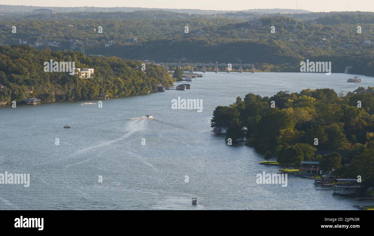 An aerial view of cityscape Austin surrounded by trees and water Stock ...