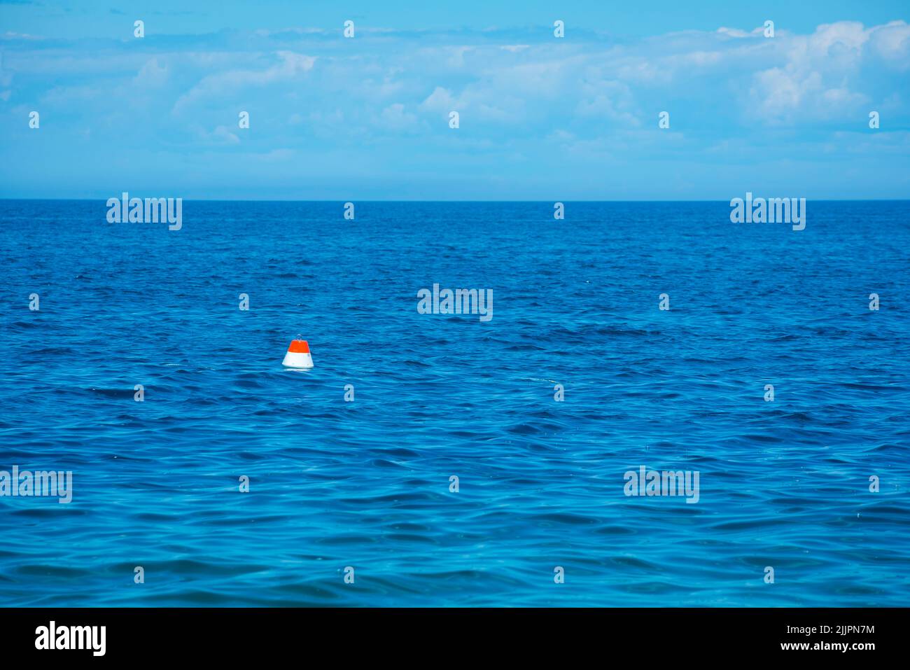 A calm sea under the cloudy sky Stock Photo - Alamy
