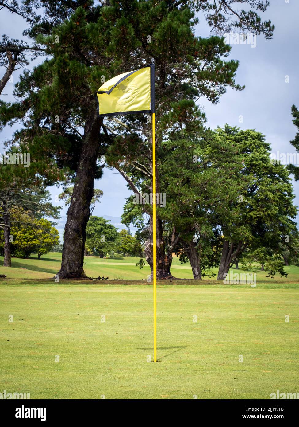 A view of Musick Point golf course grounds, yellow flagstick pin ...