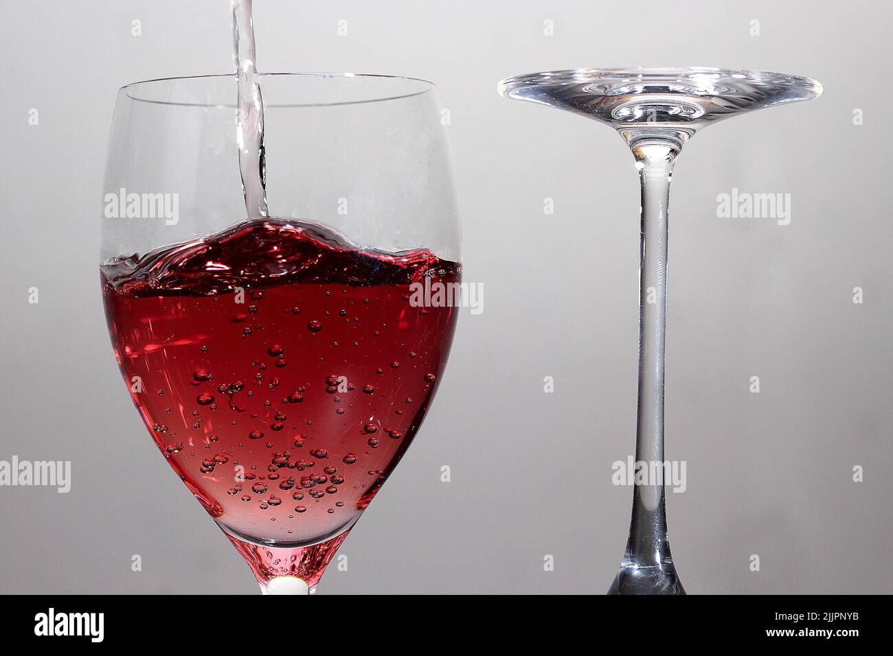 A closeup of pouring wine into a glass Stock Photo - Alamy