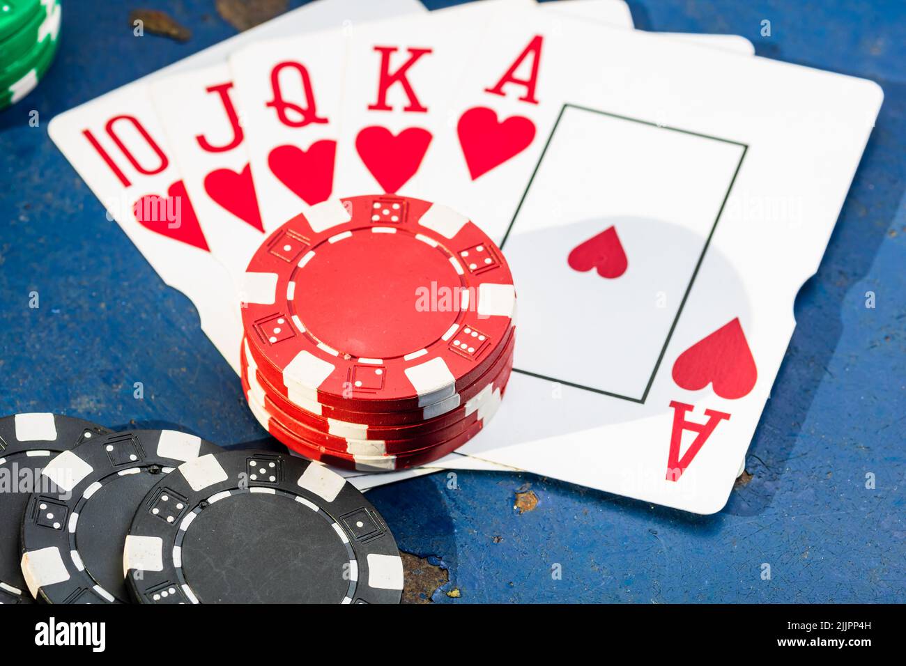 A closeup shot of stacks of poker chips with money and cards Stock ...