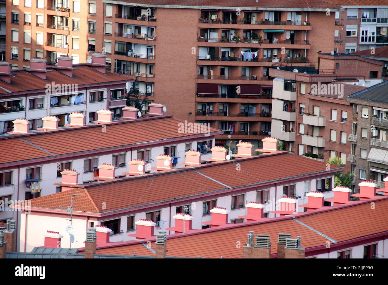 An aerial view of the roofs of red-tiled buildings in Bilbao Stock ...