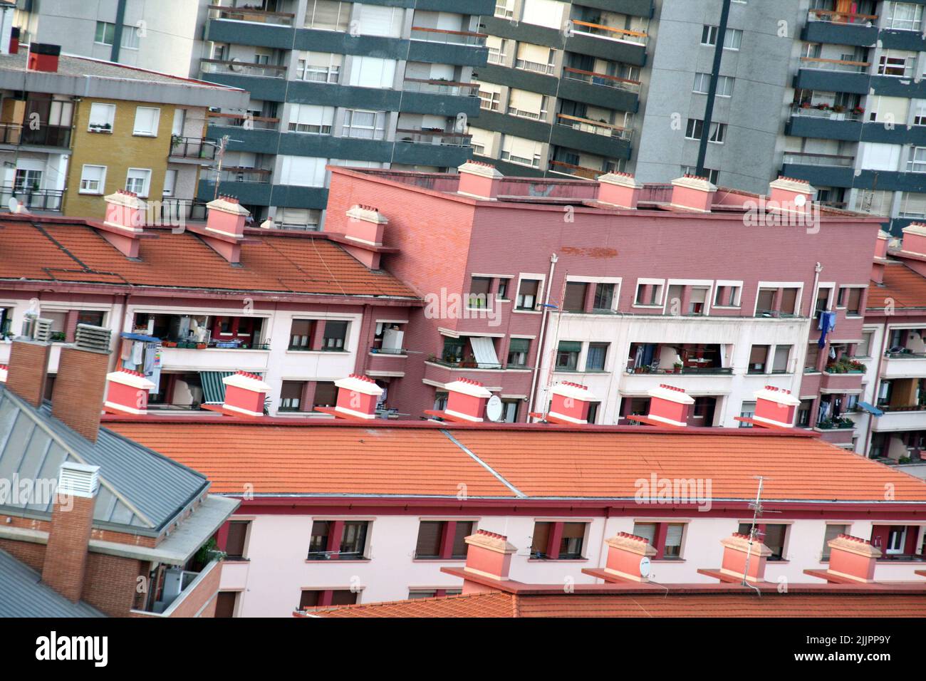 A view of the beautiful city Bilbao with red-roofed buildings, Spain ...