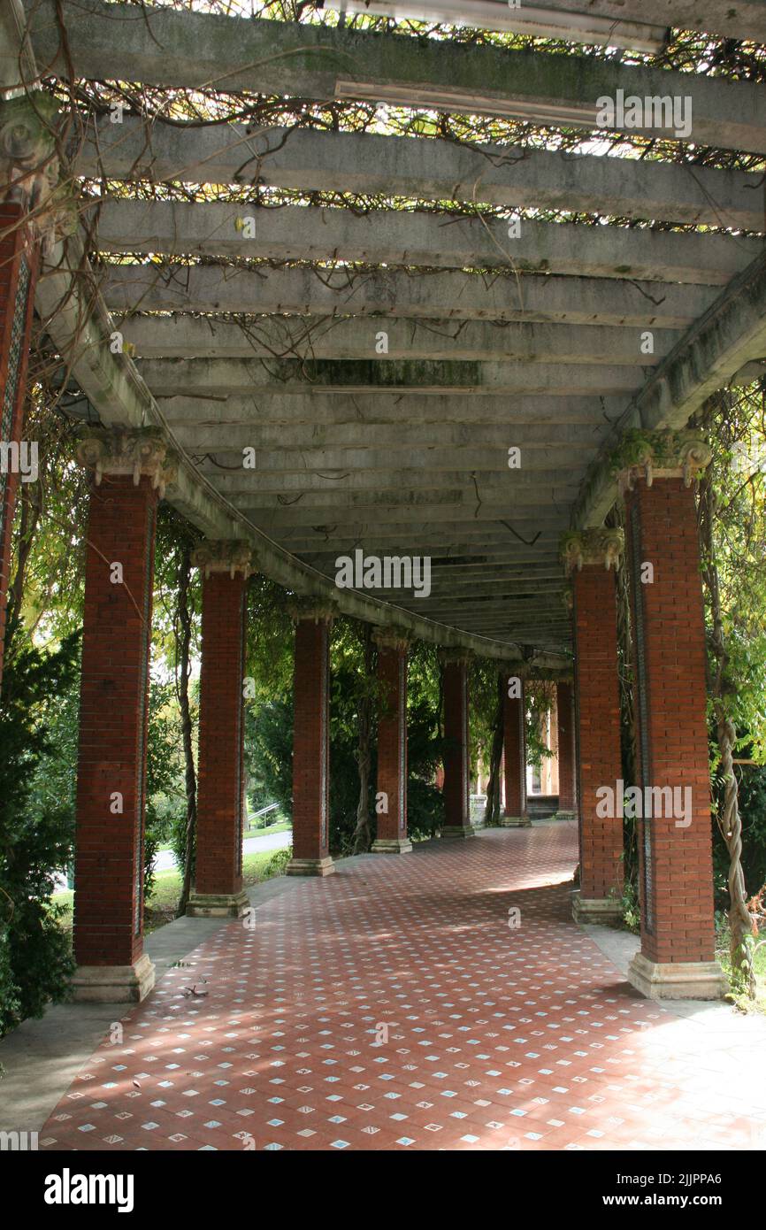 A vertical shot of old park hallway columns in the city of Bilbao ...