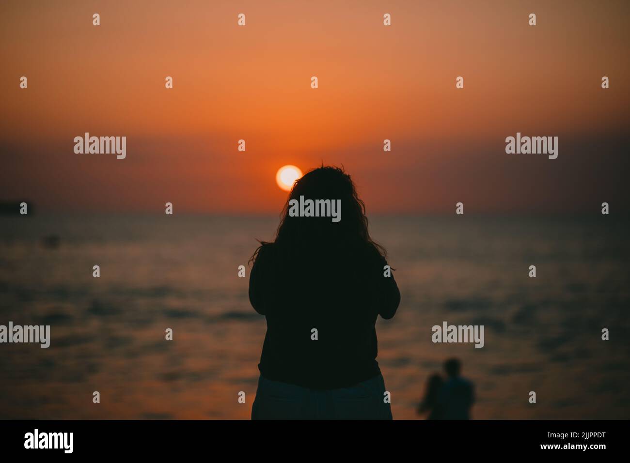 A back view of a female at sunset Stock Photo - Alamy