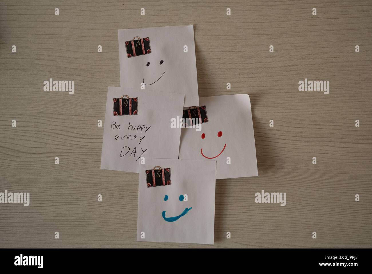 White sticky notes with smiley faces and a motivational quote on a ...