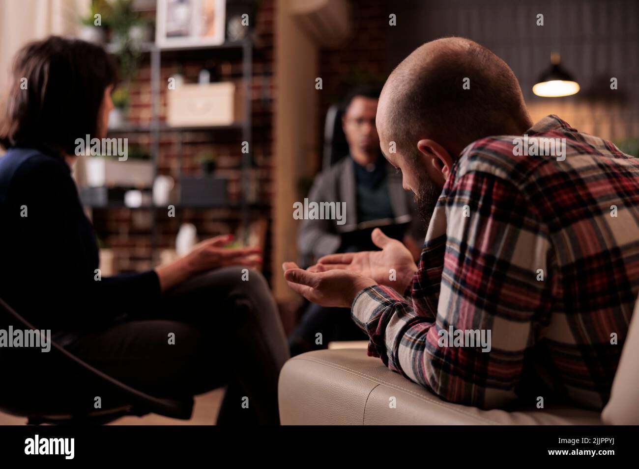 Unhappy husband and wife in relationship attending couple therapy with ...