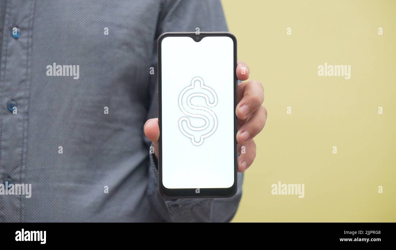 A closeup of a man holding a phone with a 2D illustration of a dollar ...