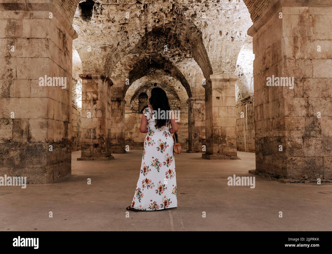 A back view of a Caucasian female tourist standing in the underground ...