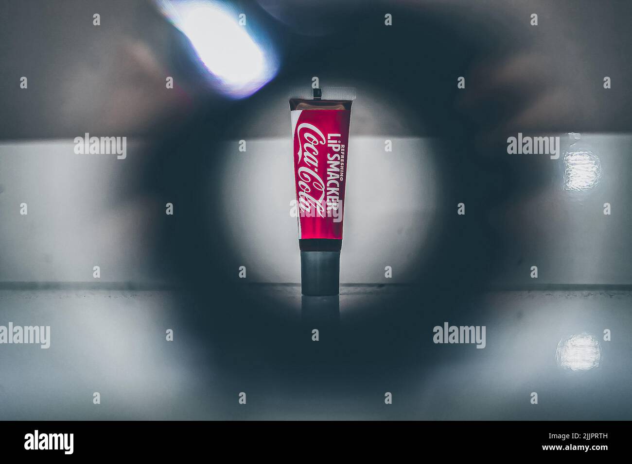 A closeup of a coca cola lip stick from a hole Stock Photo - Alamy