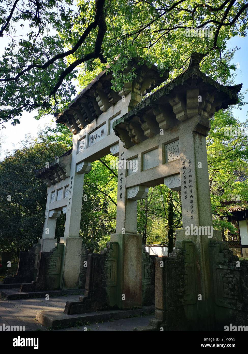 A side shot of old traditional Chinese gates under trees branches Stock ...