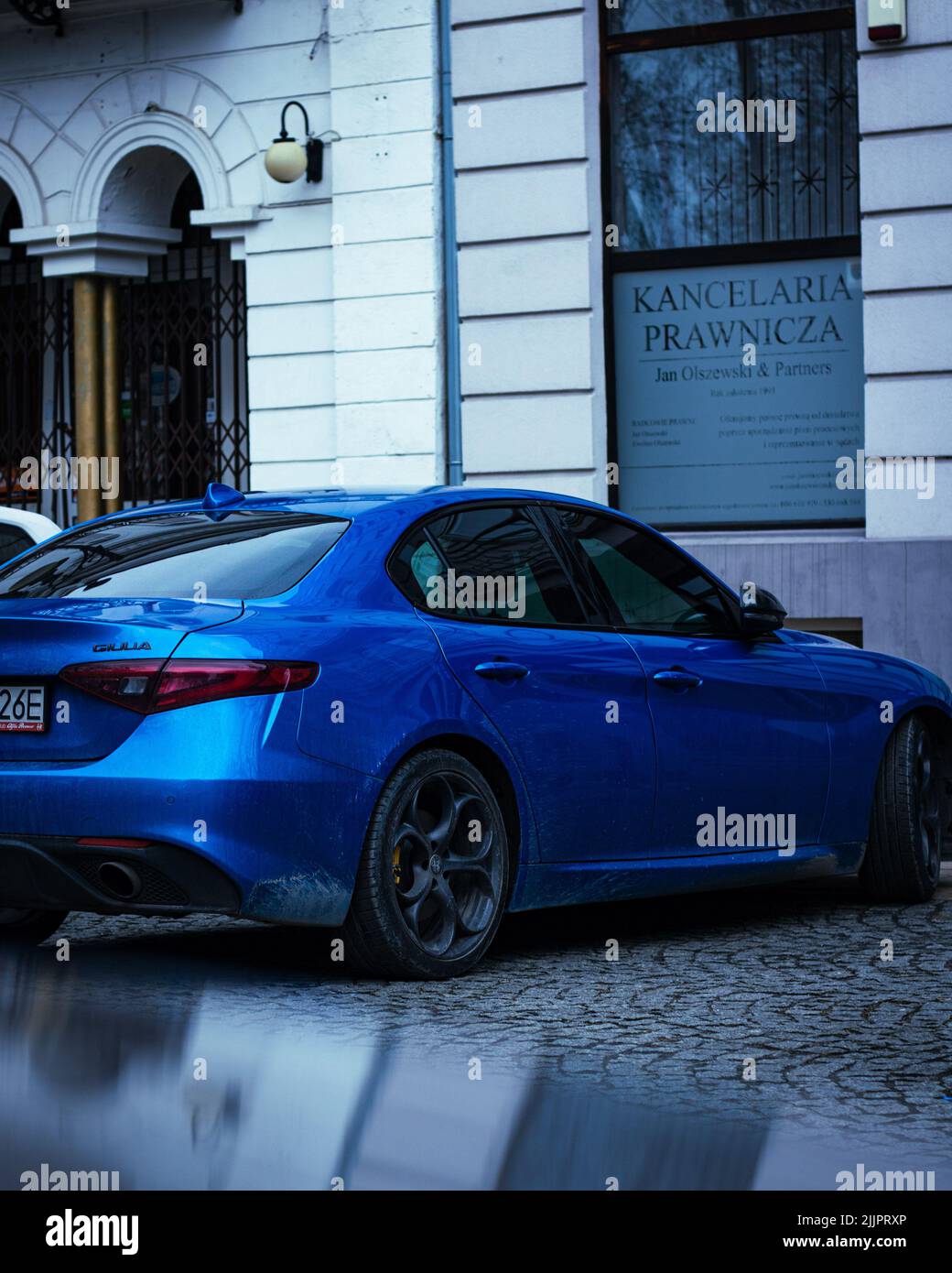 A closeup of a blue Alfa Romeo Giulia quadrifoglio on a building ...