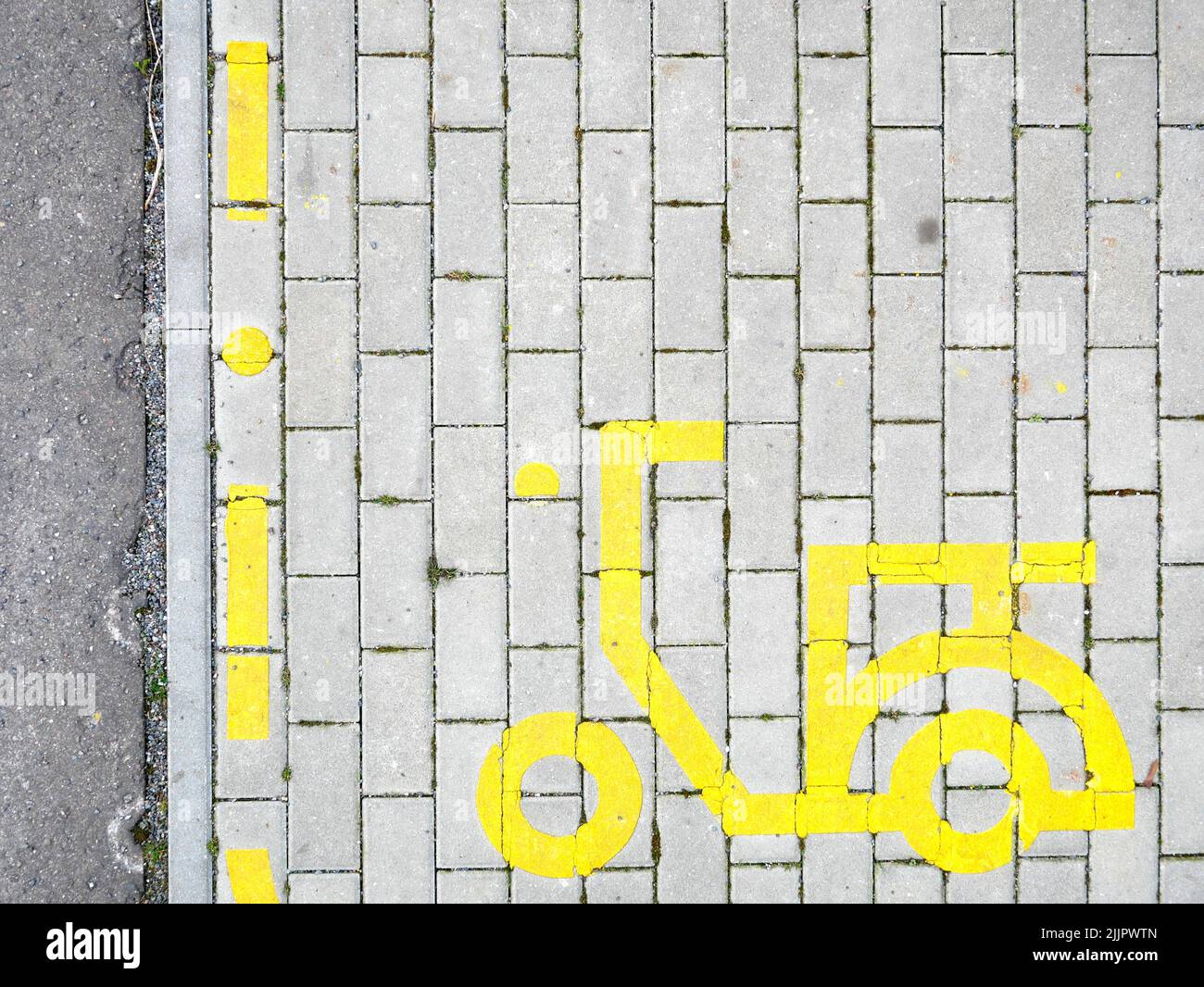 Yellow motorcycle symbol parking lot on pavement Stock Photo - Alamy