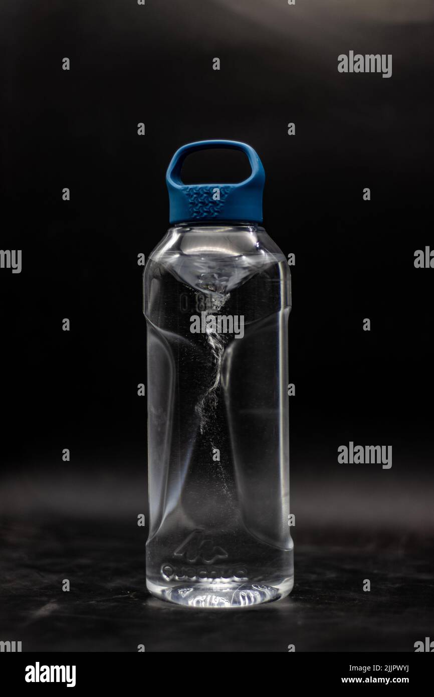 A vertical shot of decathlon quechua 0.8L water bottle for hiking with ...