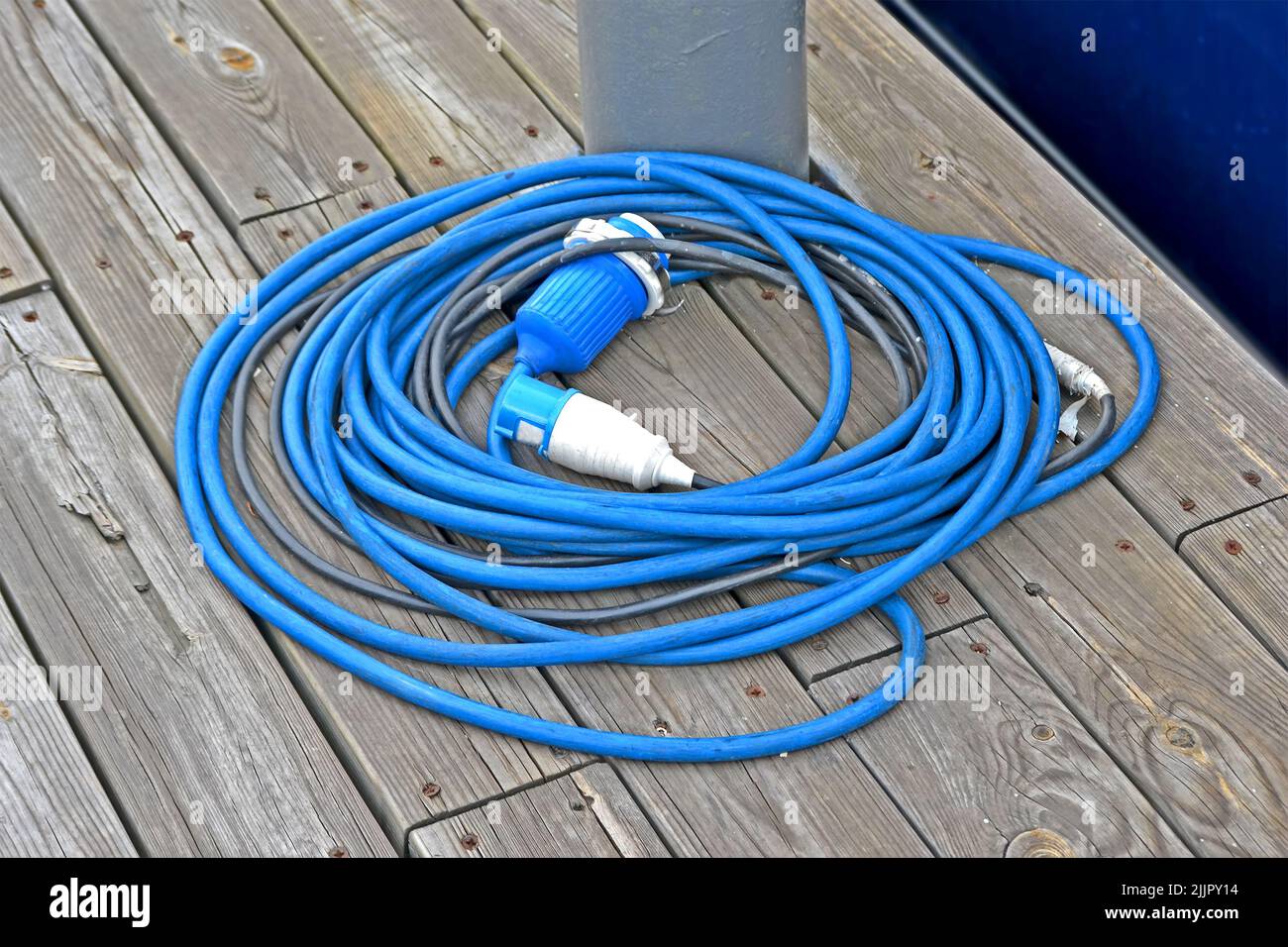 power cable roll with waterproof connector on vintage wooden surface ...