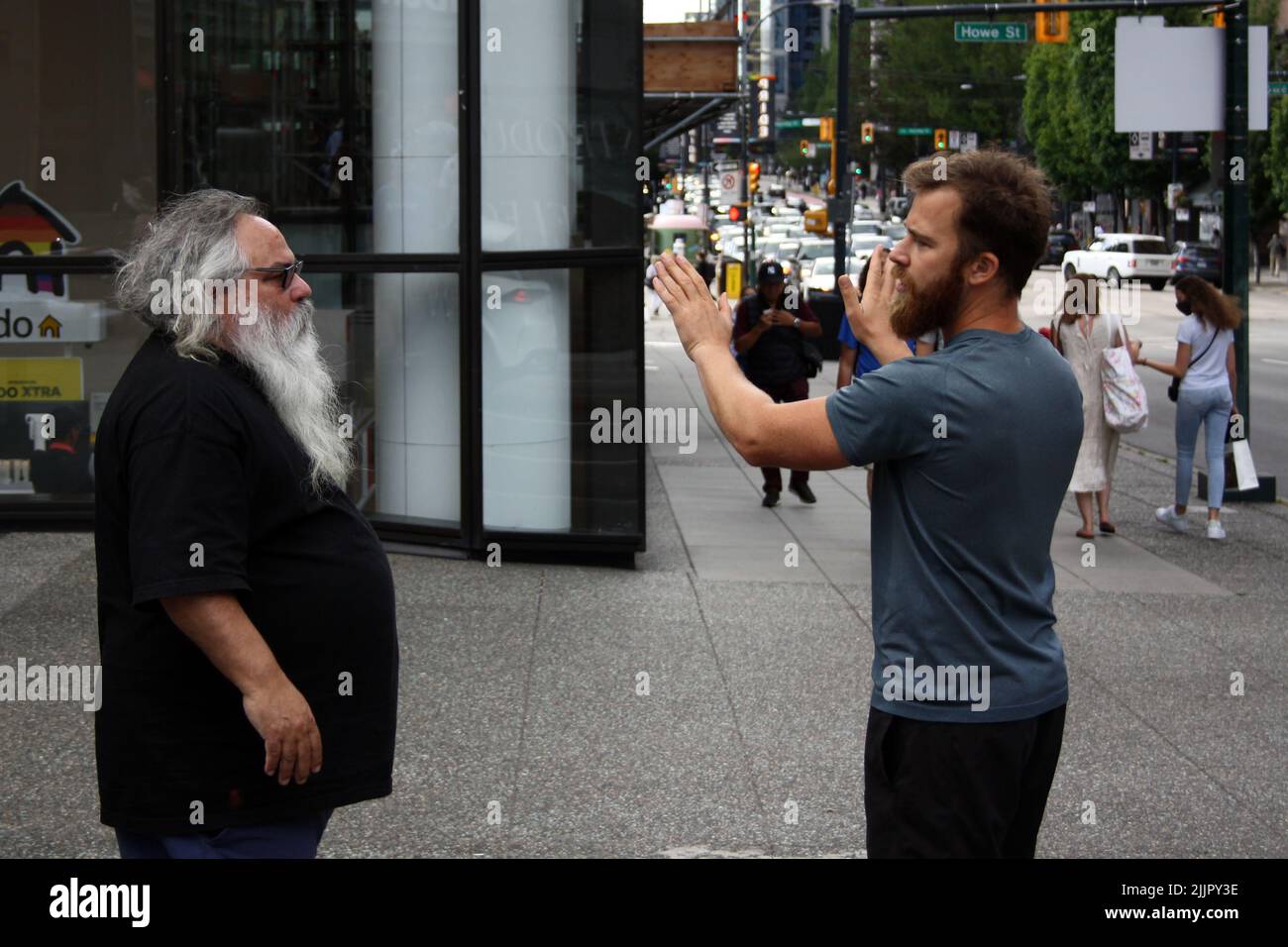 Two people talking in the downtown Vancouver, British Columbia, Canada ...
