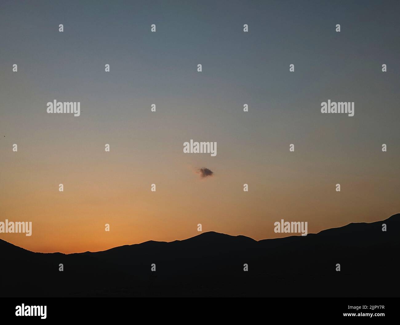 A beautiful view of a single tiny cloud in sunset sky Stock Photo - Alamy