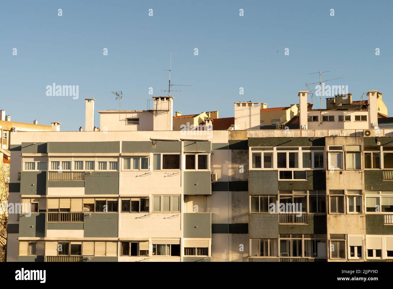 A view of beige residential building facade with the last floors in ...