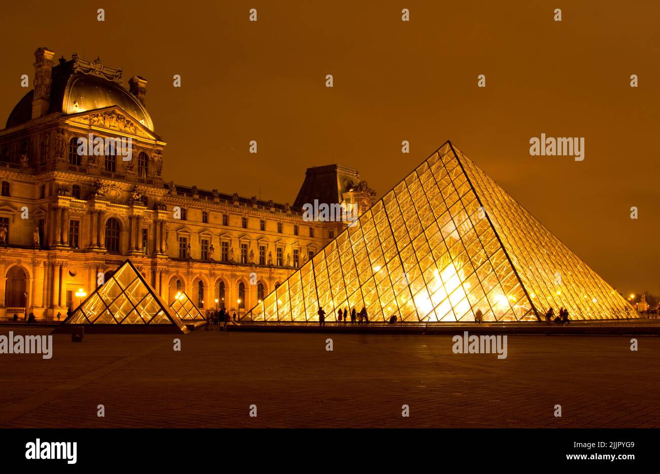 A beautiful shot of the Louvre in Paris, France at night Stock Photo ...