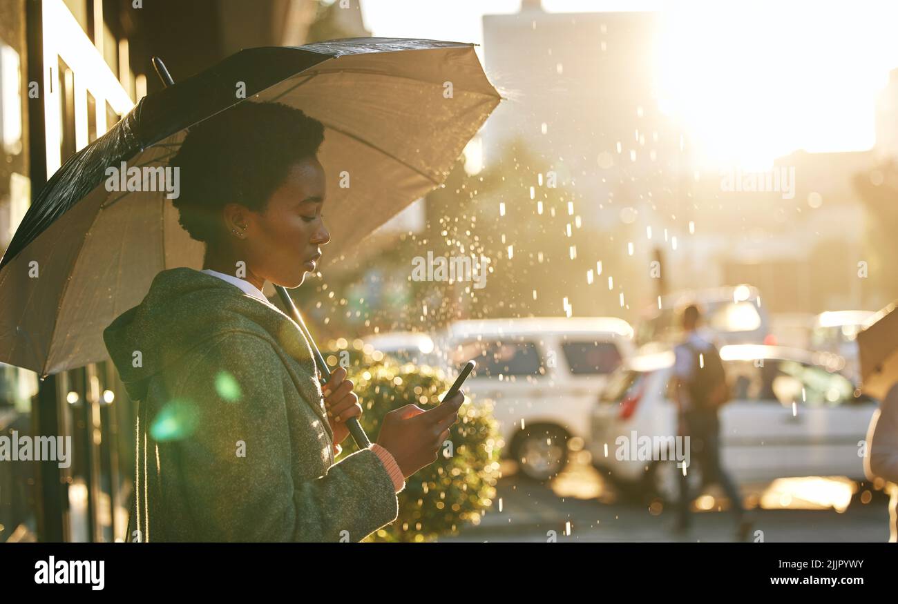 Dont let the rain pass, learn to work with it. a young businesswoman ...