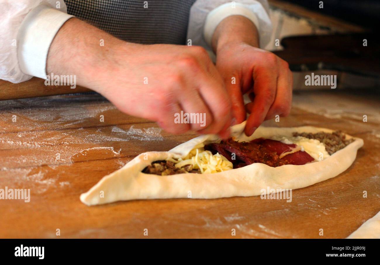 Chef making mixed pita in the kitchen Stock Photo - Alamy
