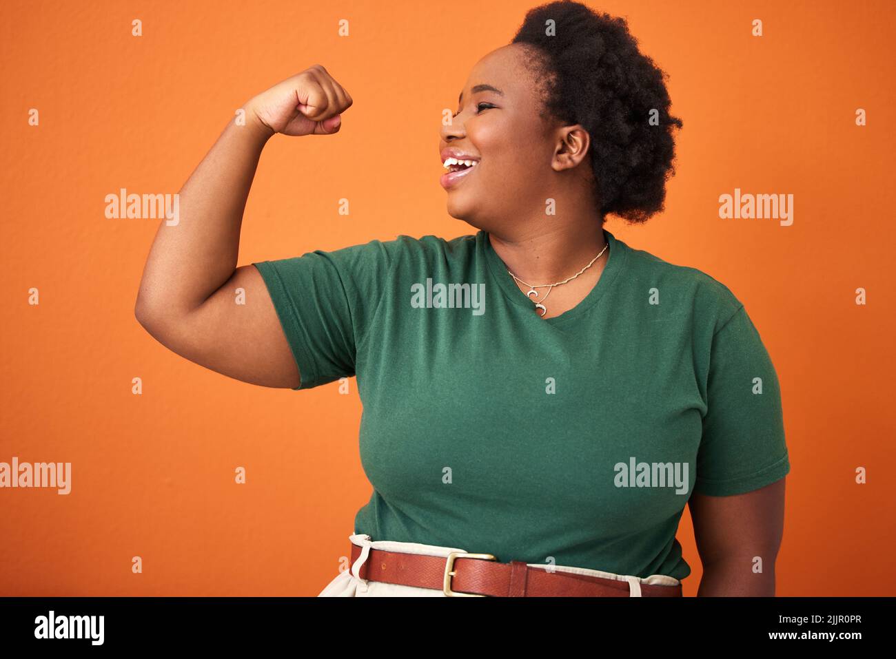 Have you ever seen muscles like this. a beautiful young woman flexing while standing against an ...