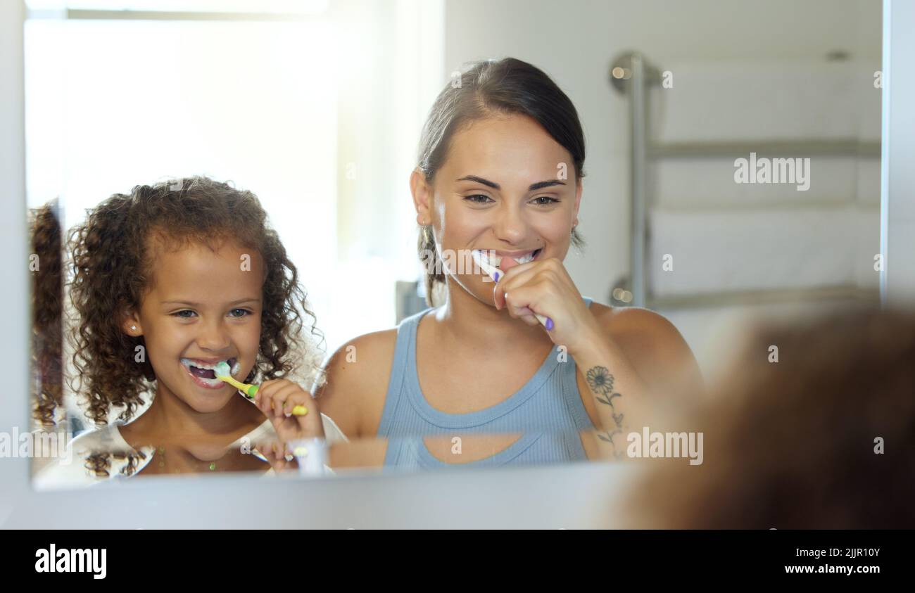 Dental care, brushing teeth and healthy routine in mother and daughter ...