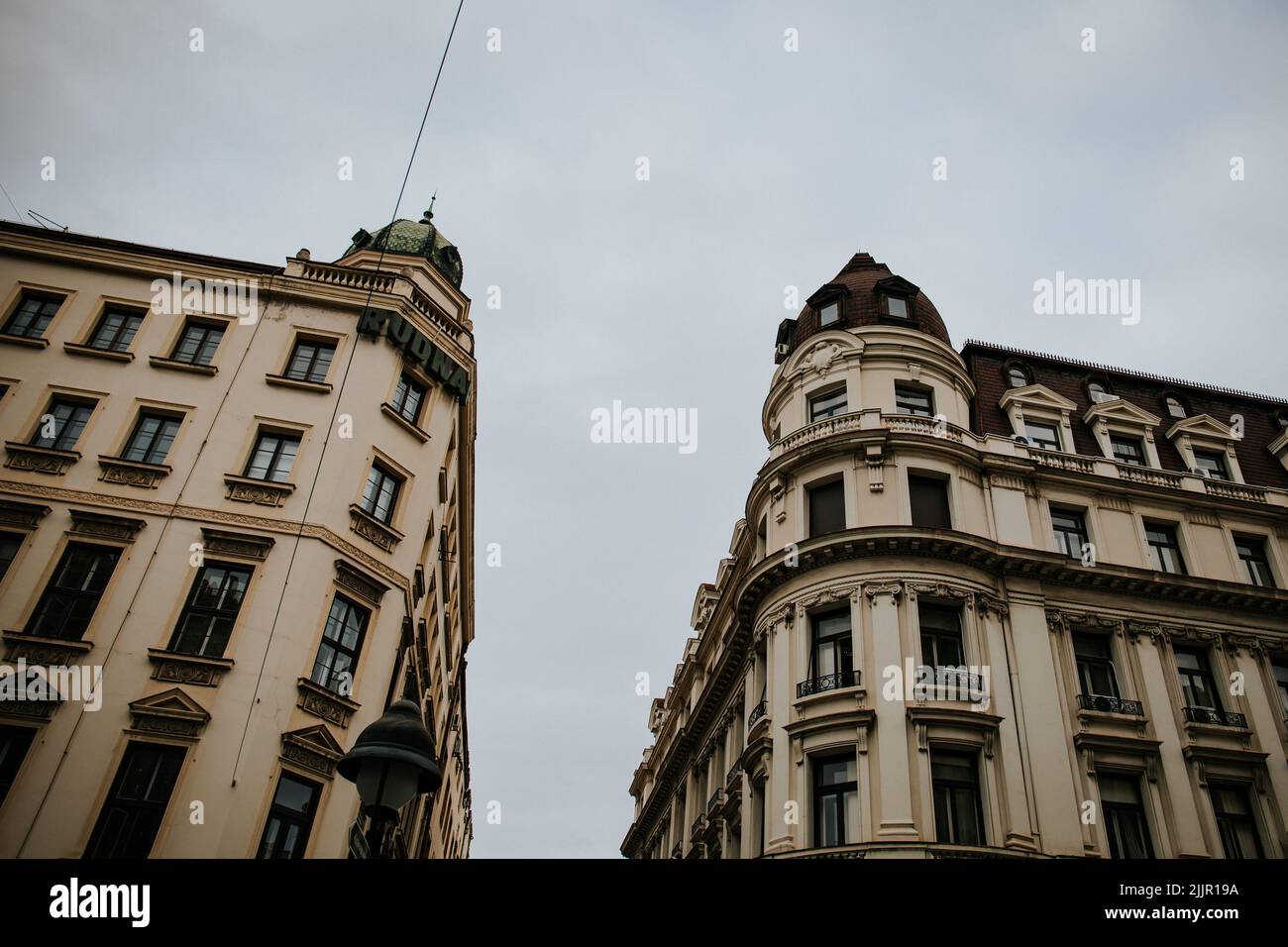 A low angle shot of the corners of two beige buildings with beautiful ...