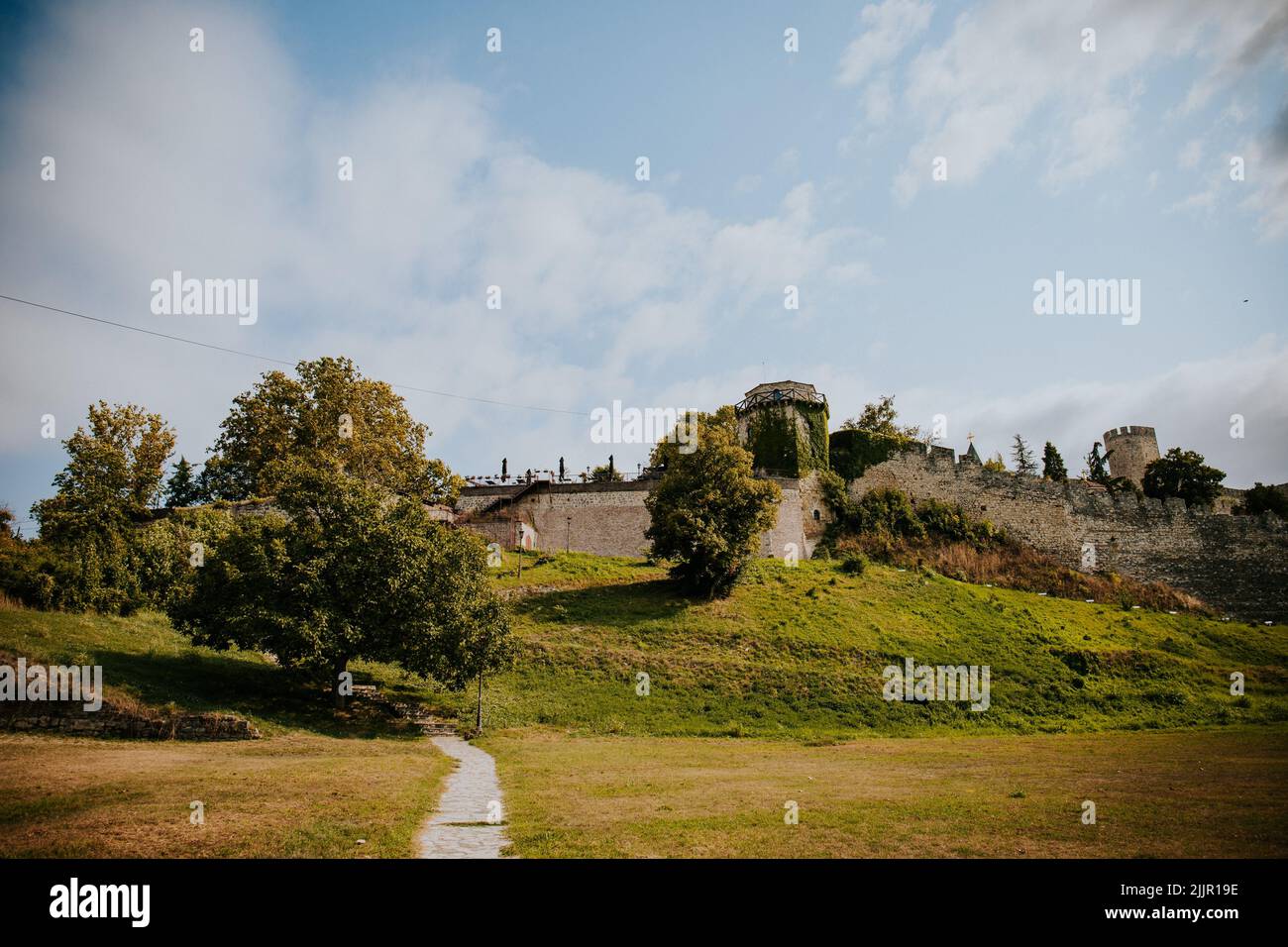 A beautiful view of an ancient fortress surrounded by green trees Stock ...