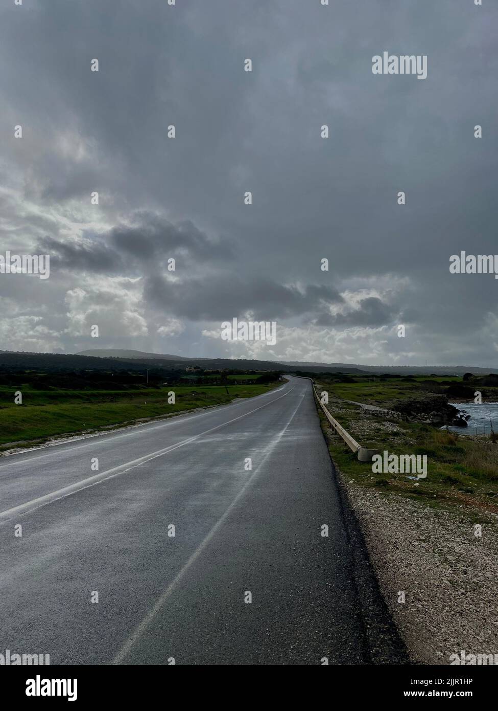An empty roads running through a meadows spectacular landscapes in a ...