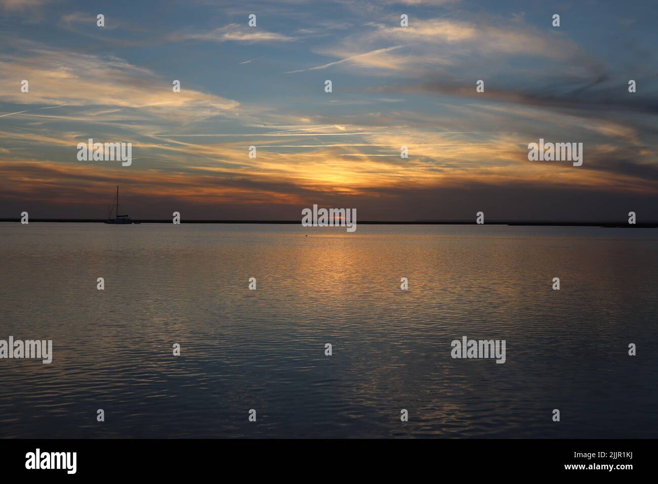 A beautiful view of a calm sea during sunset Stock Photo - Alamy