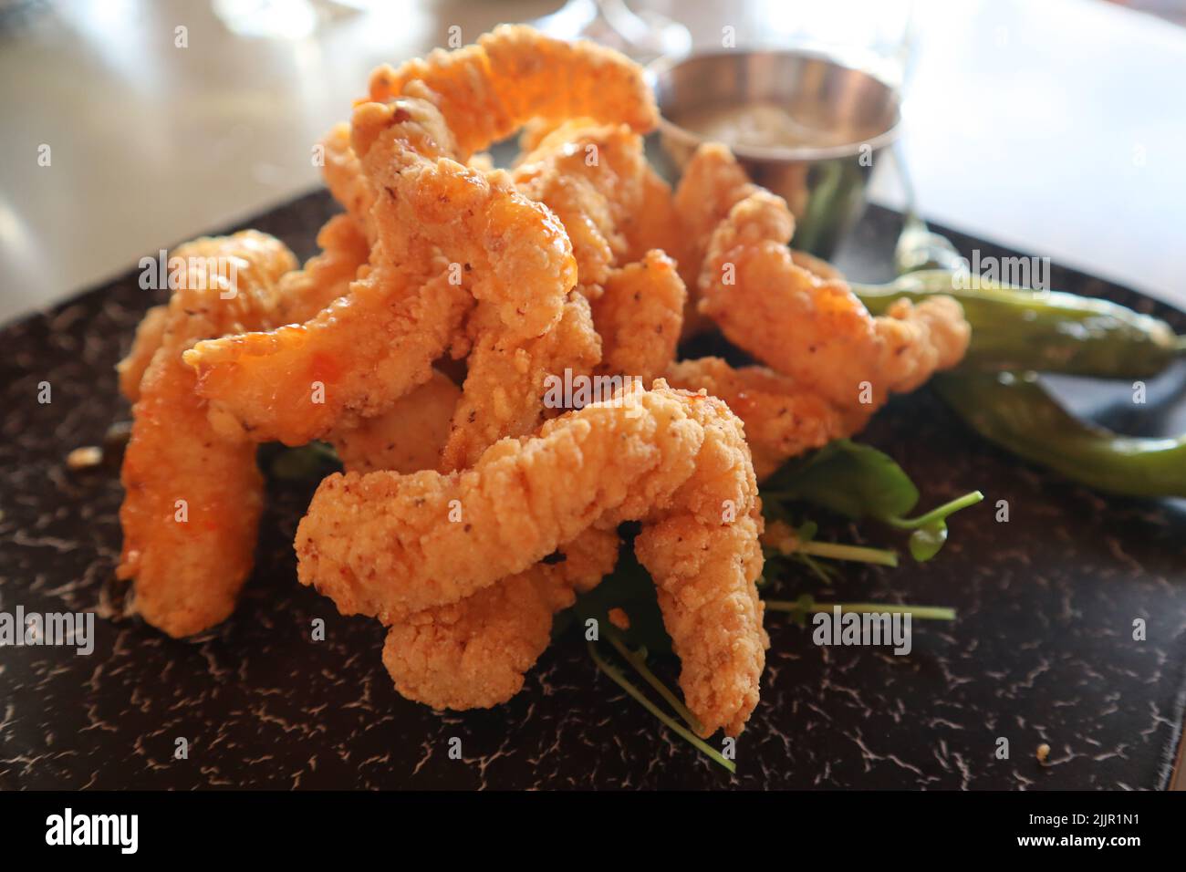 A close up of calamari appetizer at a seafood restaurant Stock Photo ...