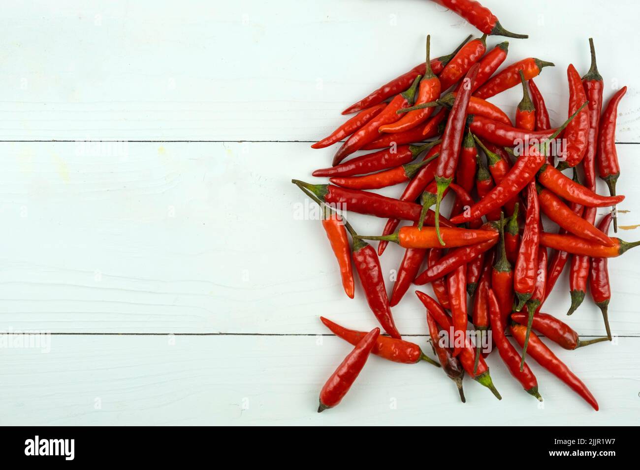 Red chilli pepper in the tray on a white table. View from above Stock ...