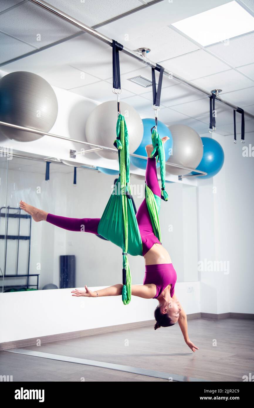 A vertical shot of a Caucasian woman exercising in the gym Stock Photo ...