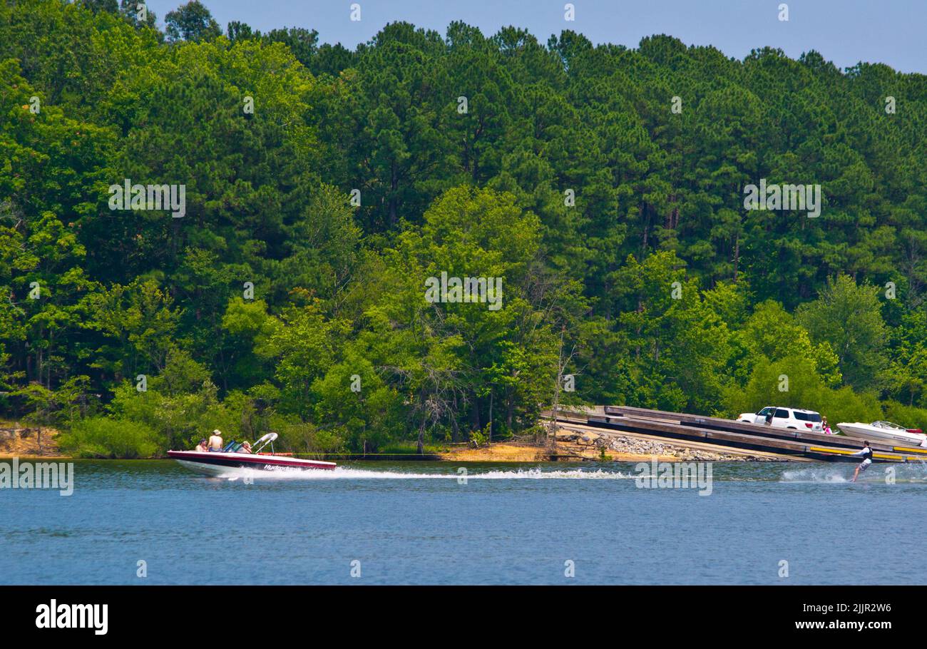 A scenic view of a body of water with a small boat against a bright ...