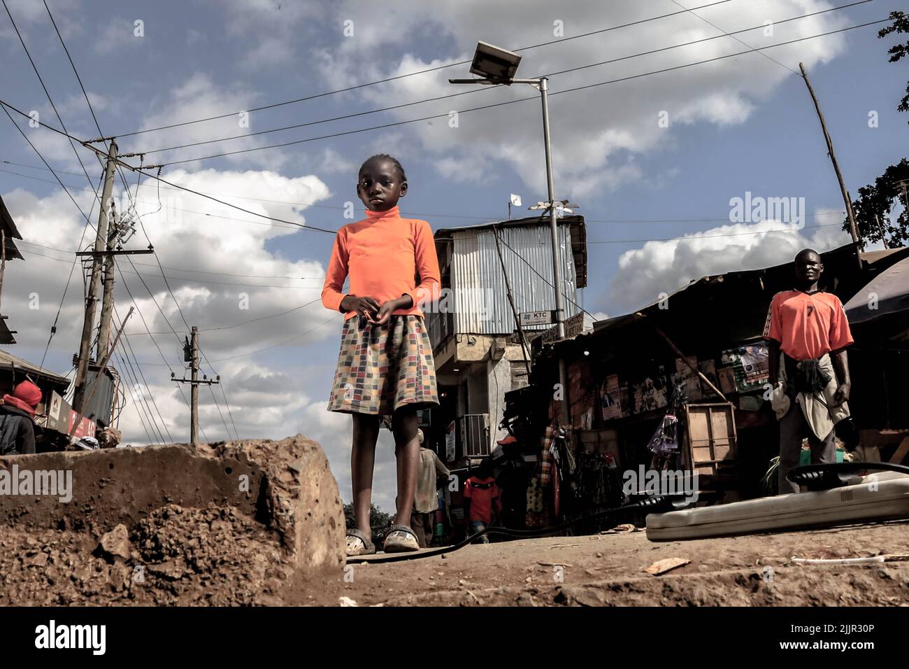 A young girl poses for photo along the streets of Kibera Slum in ...