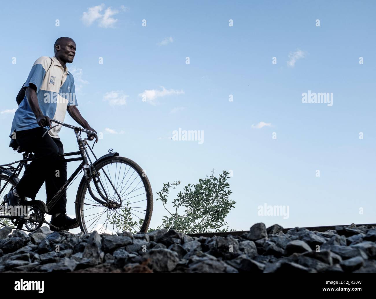 A man cycles along a train line running through the centre of Kibera ...