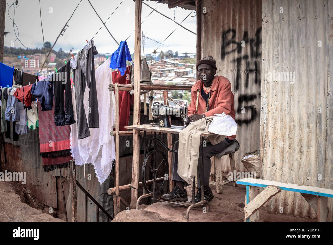 A tailor repairing clothes in Kibera Slum, Nairobi. Life inside Kibera ...