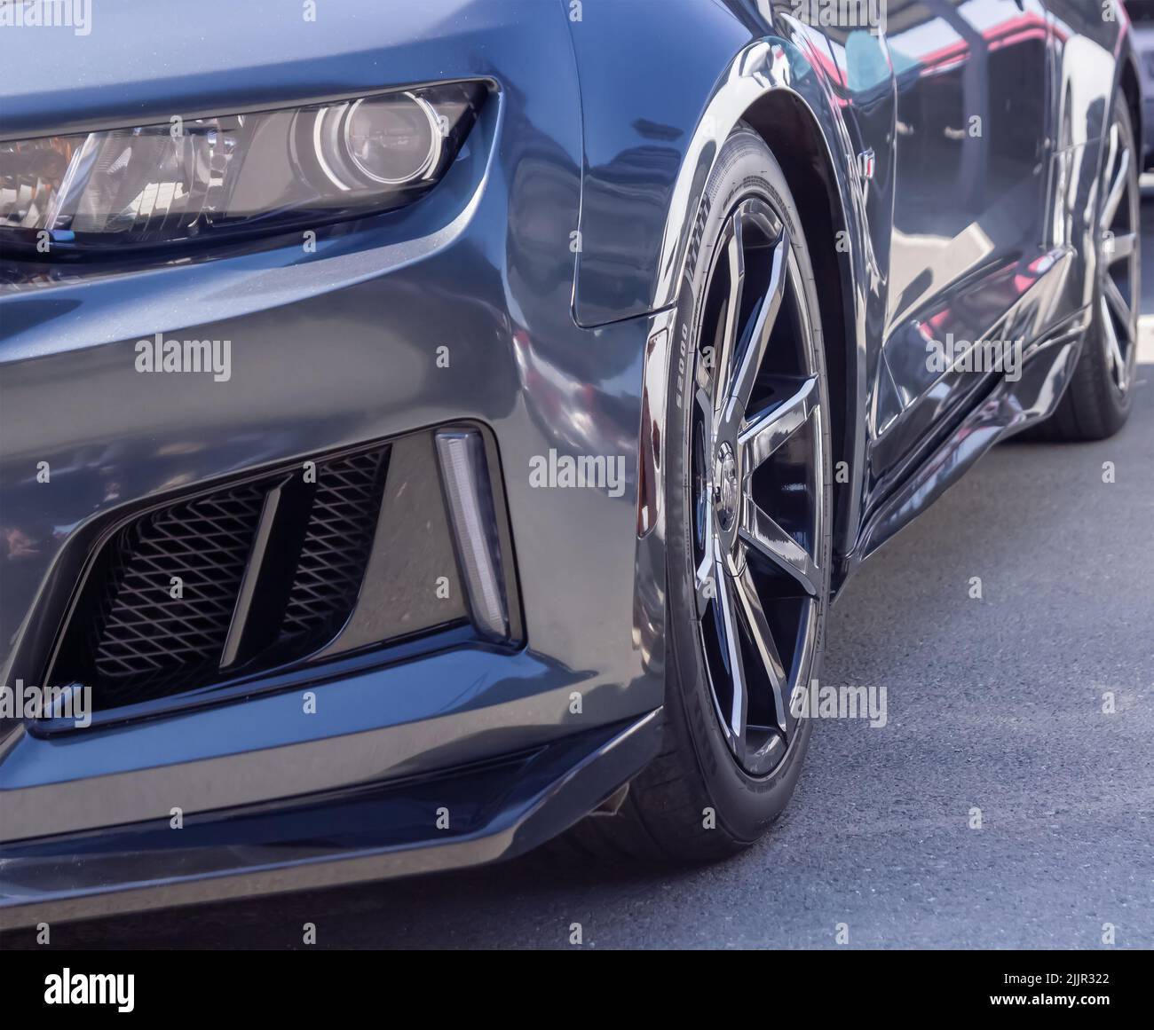 A black sports car on a track Stock Photo - Alamy