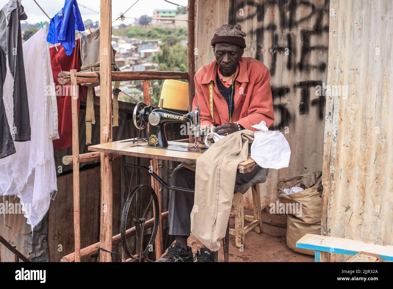 A tailor repairing clothes in Kibera Slum, Nairobi. Life inside Kibera ...