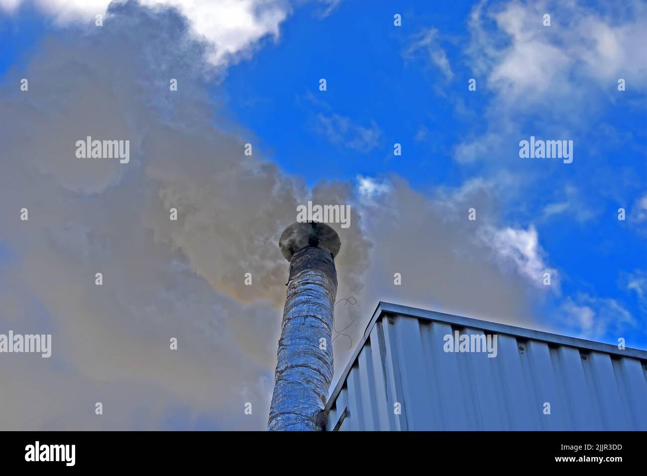 black smog from high industrial pipe with silver insolation on blue sky ...