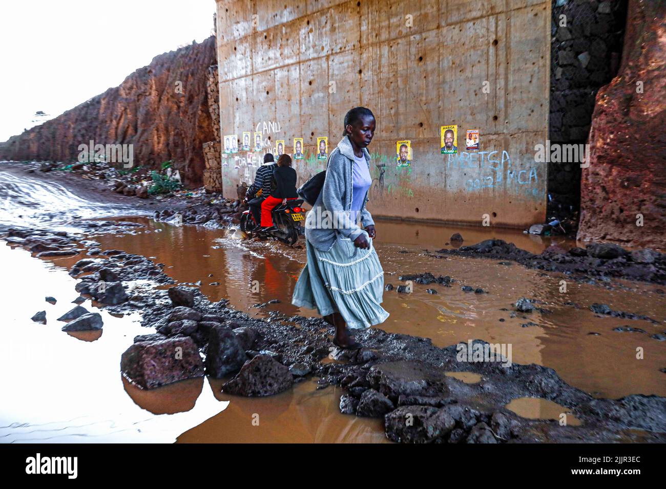 A woman walks past an unfinished construction of Kibra -Southern bypass ...