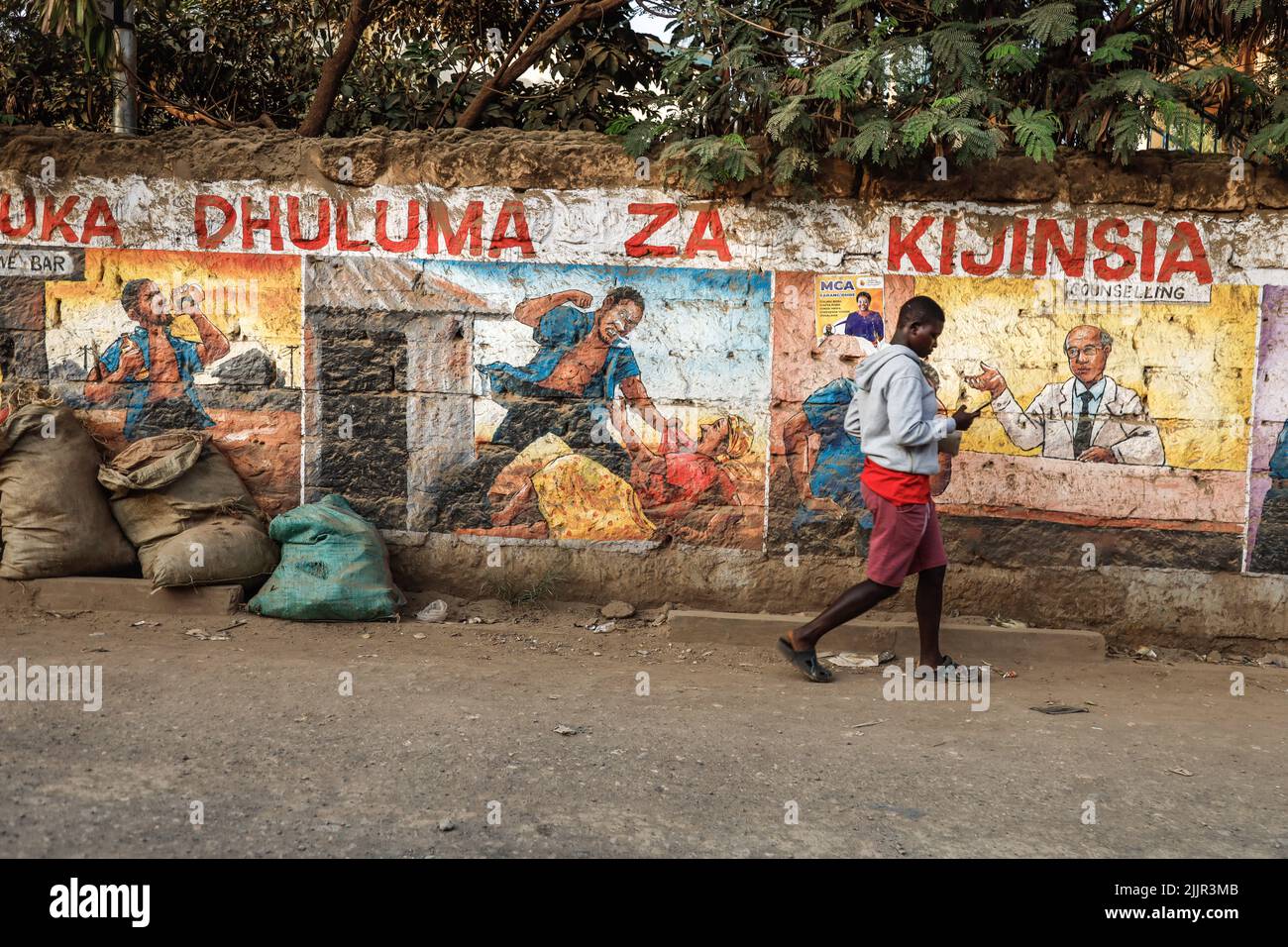 Nairobi, Kenya. 16th Mar, 2022. A woman walks past a mural painting ...
